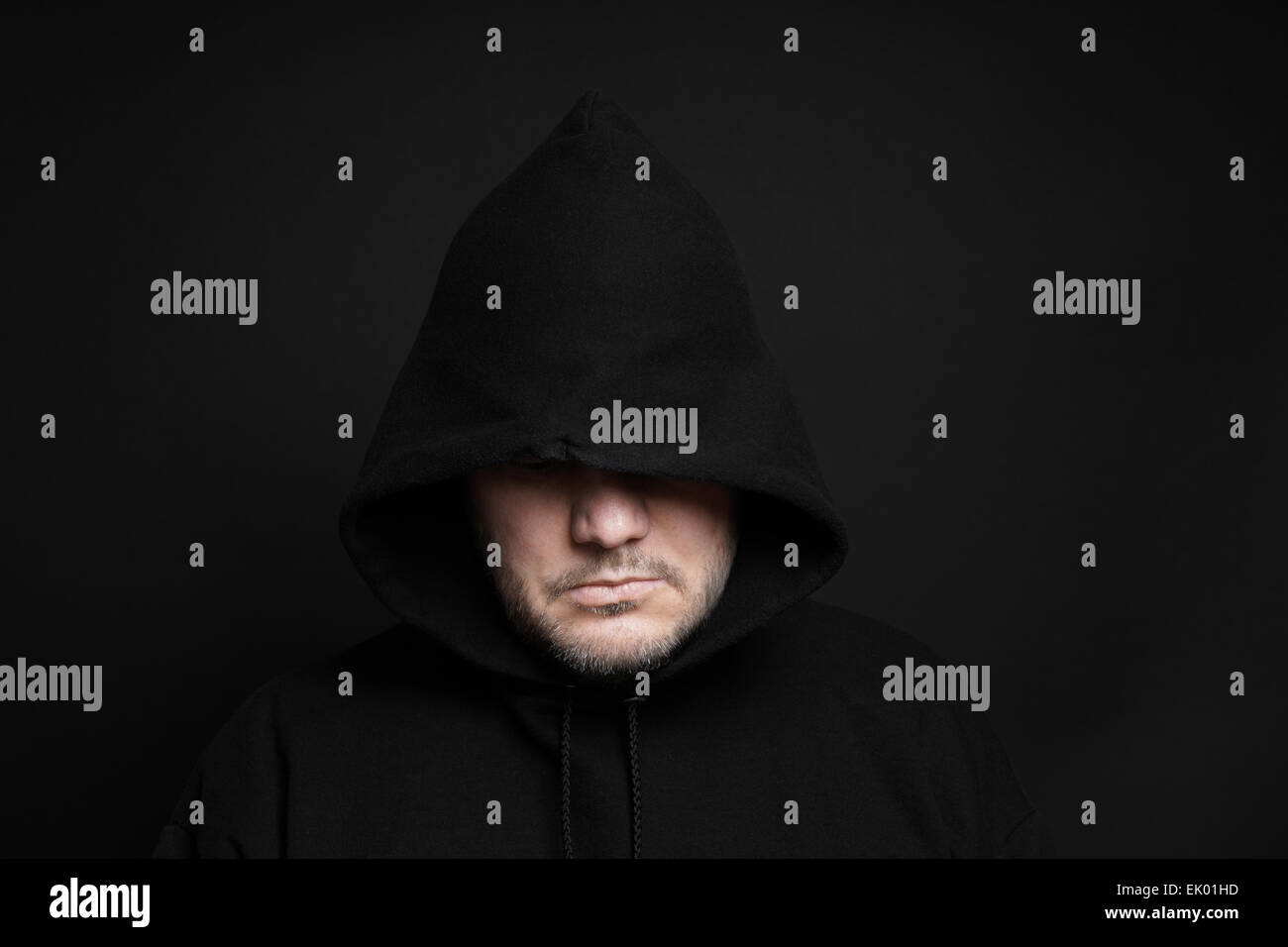 man wearing black hoodie hiding eyes Stock Photo - Alamy