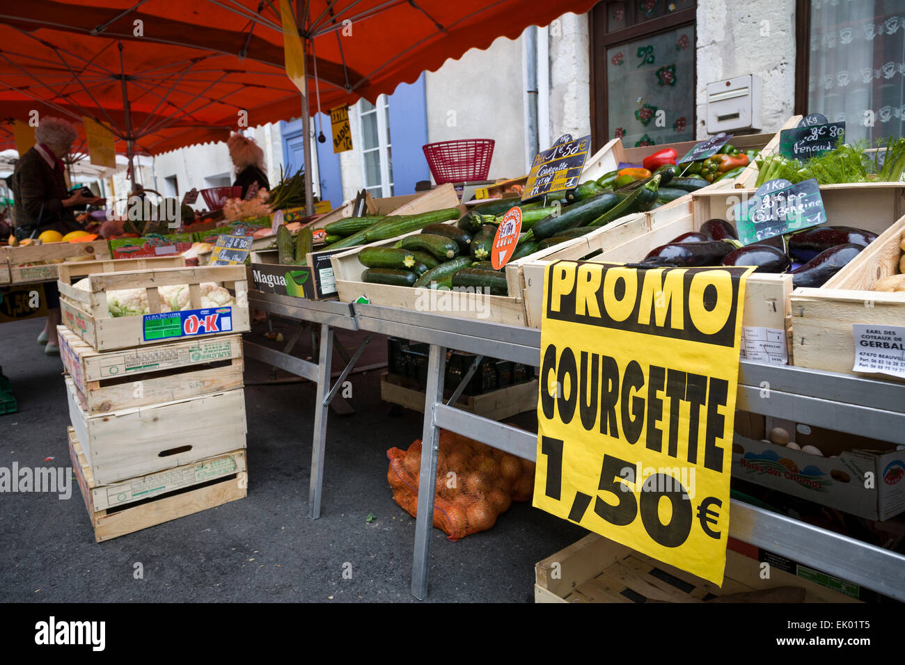 French market stall selling vegetables with a special offer on ...