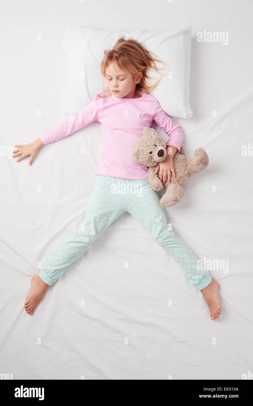 Top view of little girl sleeping in Freefaller pose Stock Photo - Alamy