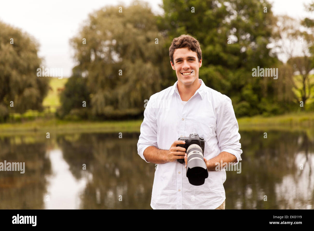 portrait of young man holding digital camera Stock Photo - Alamy