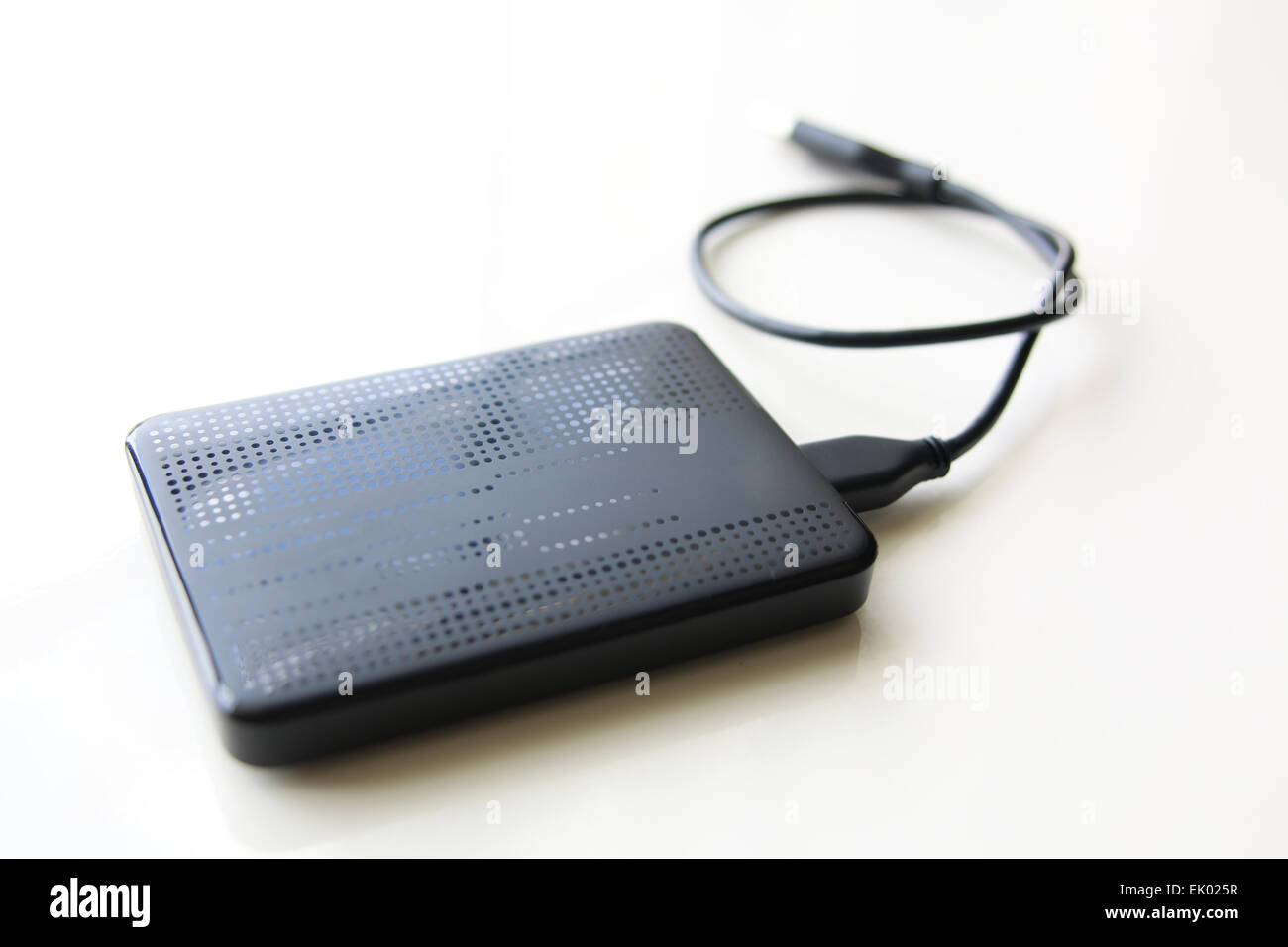 Portable external hard disk drive with USB cable on white background ...