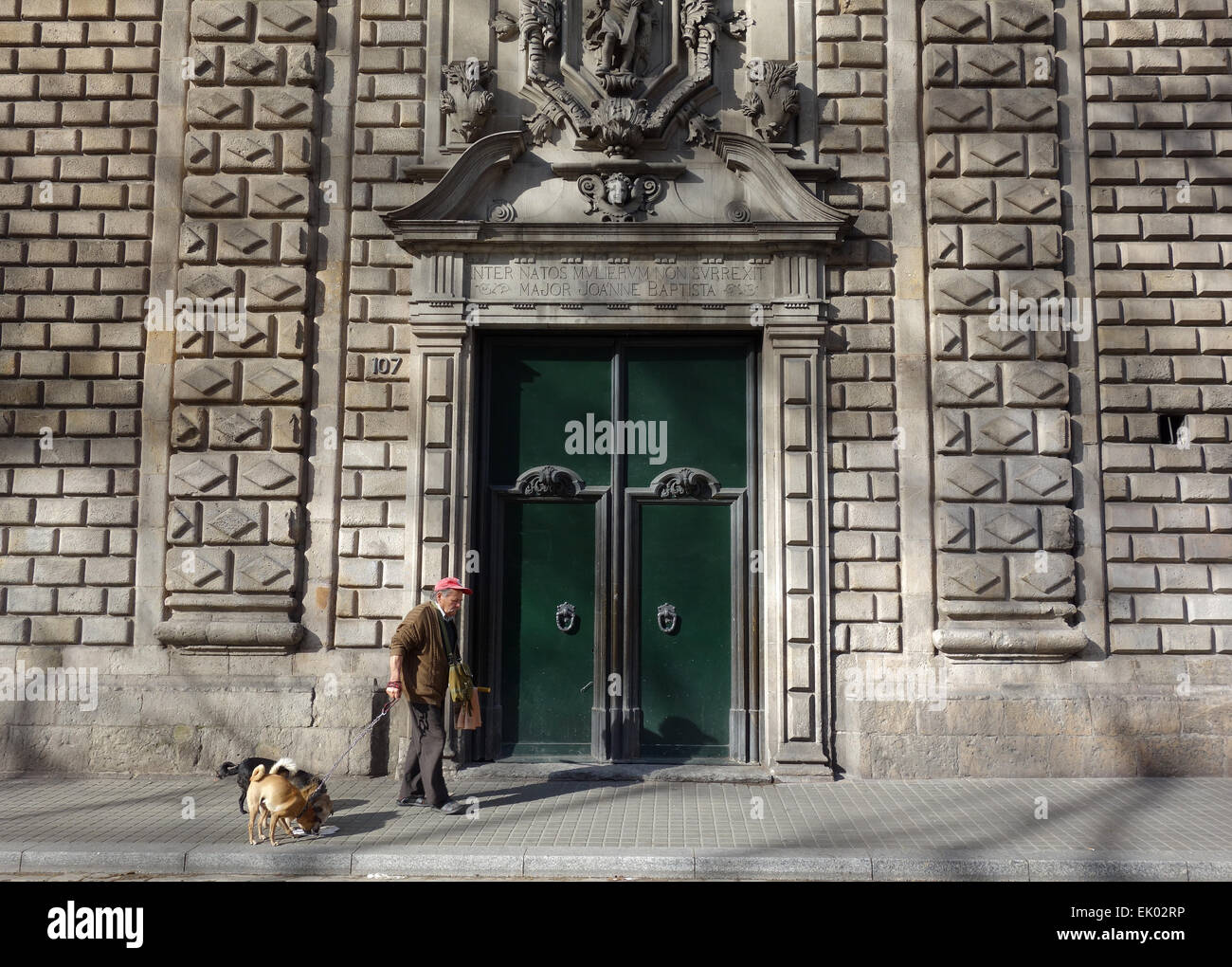 Elderly man with dogs walking past entrance to Church of Bethlehem on ...