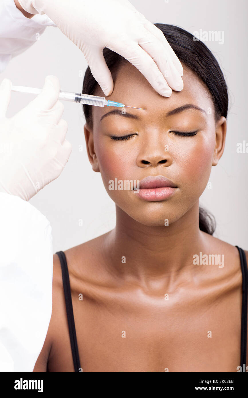 pretty woman receiving plastic surgery injection on forehead Stock ...