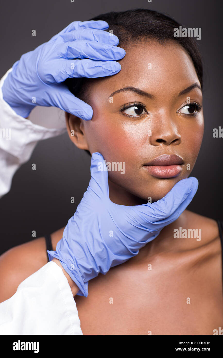 doctor checking African girl face after plastic surgery Stock Photo - Alamy