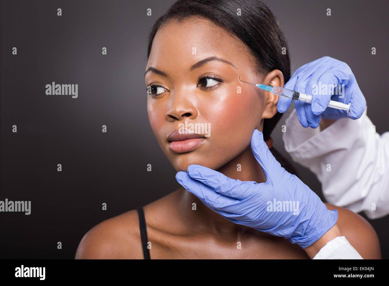 beautiful afro American woman receiving plastic surgery injection on ...