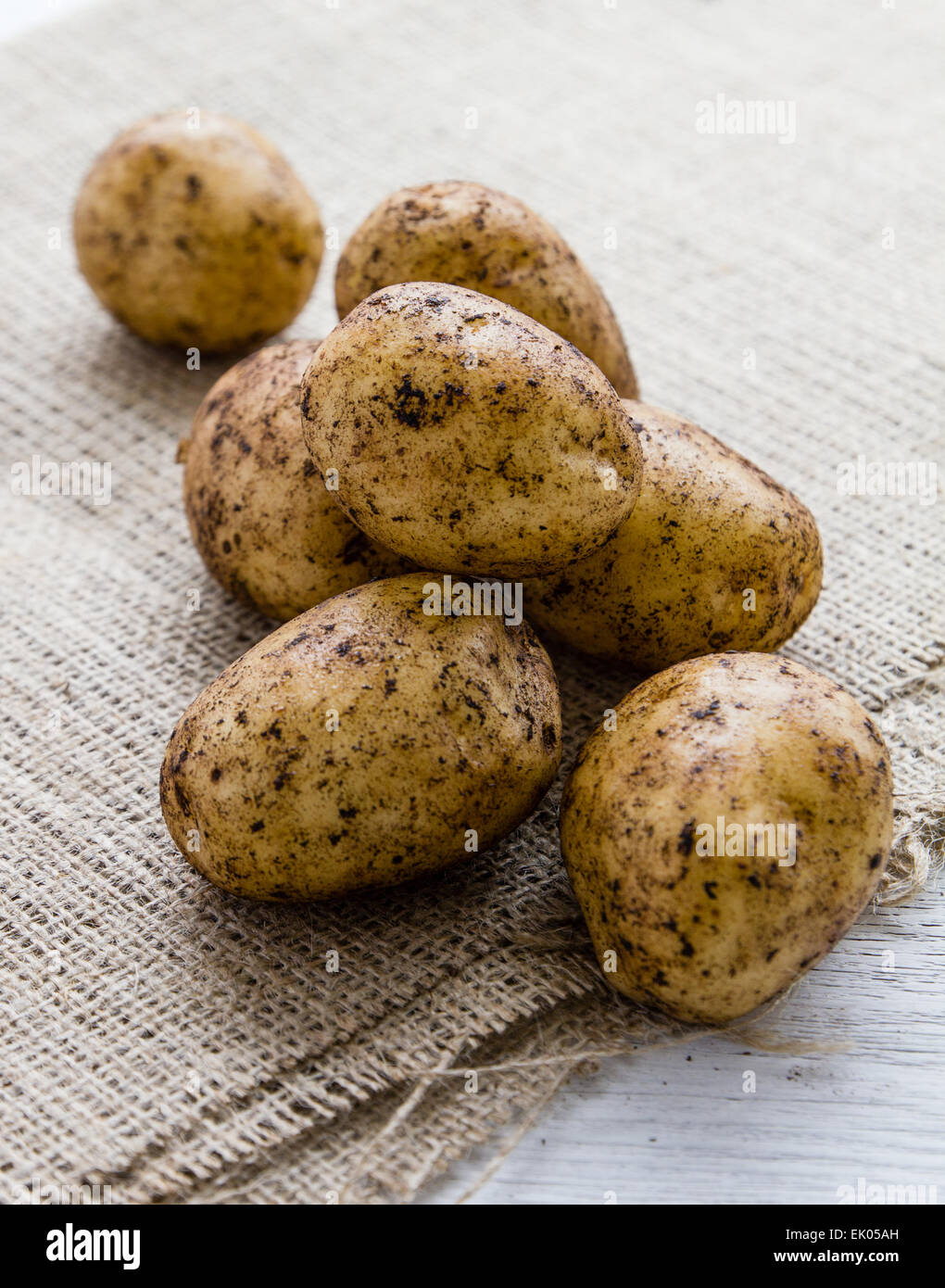 Fresh small new potatoes on hessian background Stock Photo - Alamy