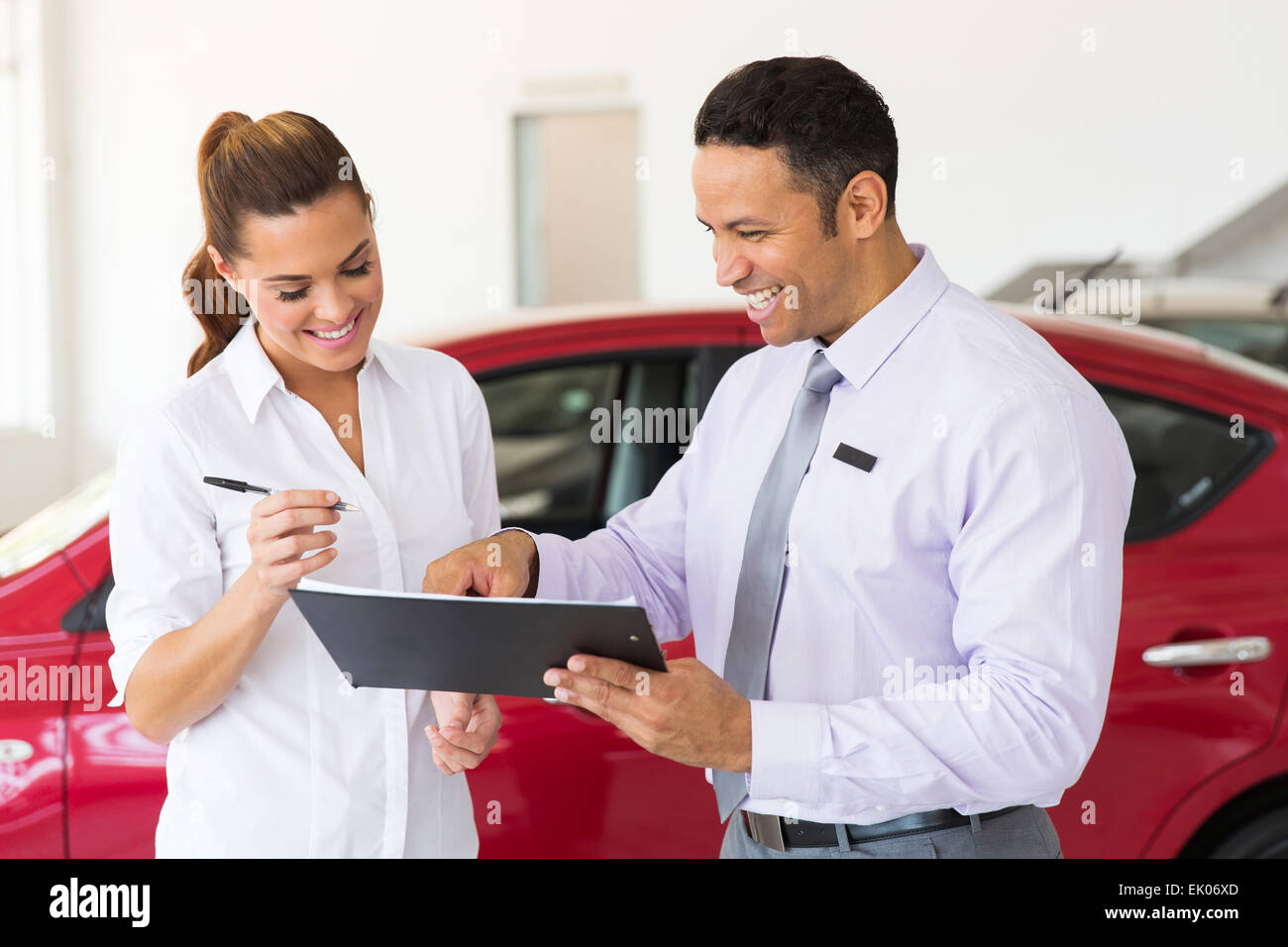 happy woman buying a new car at vehicle showroom Stock Photo - Alamy