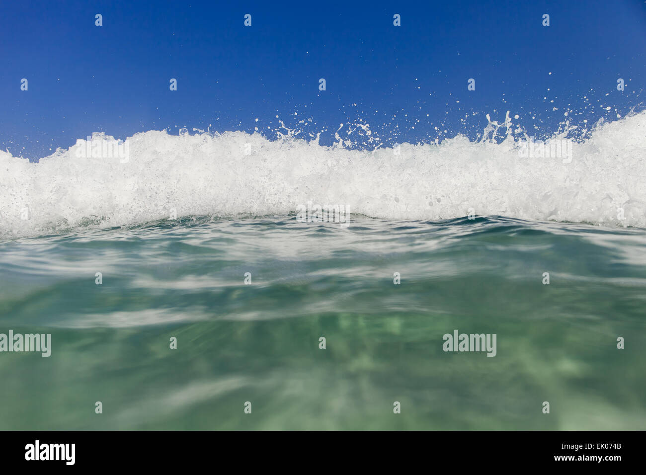 sea wave with waterline and blue sky Stock Photo - Alamy