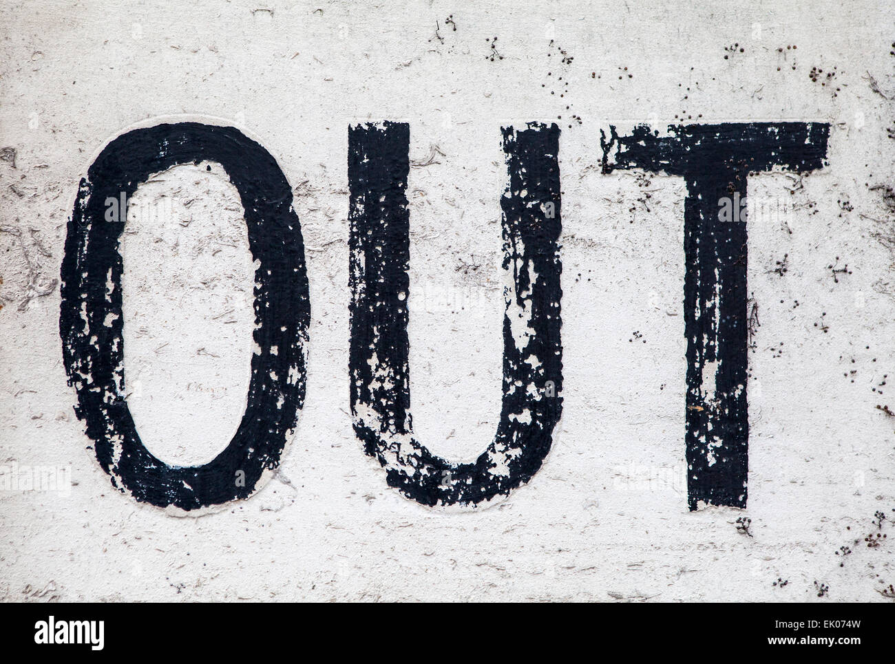 The word OUT etched on a won and textured wall Stock Photo - Alamy