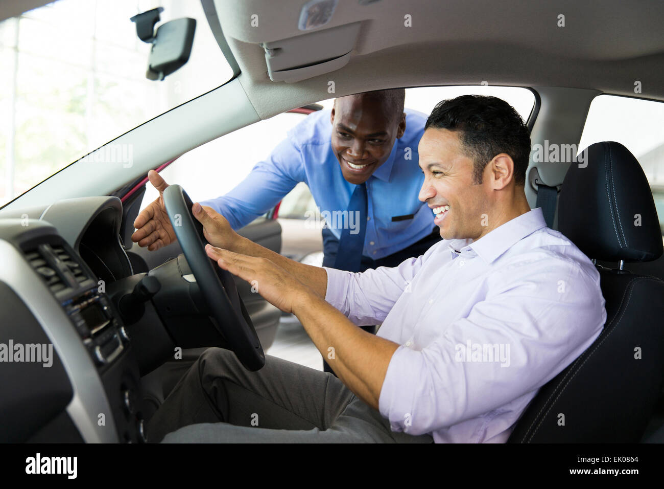 friendly African salesman explaining car features to customer Stock ...