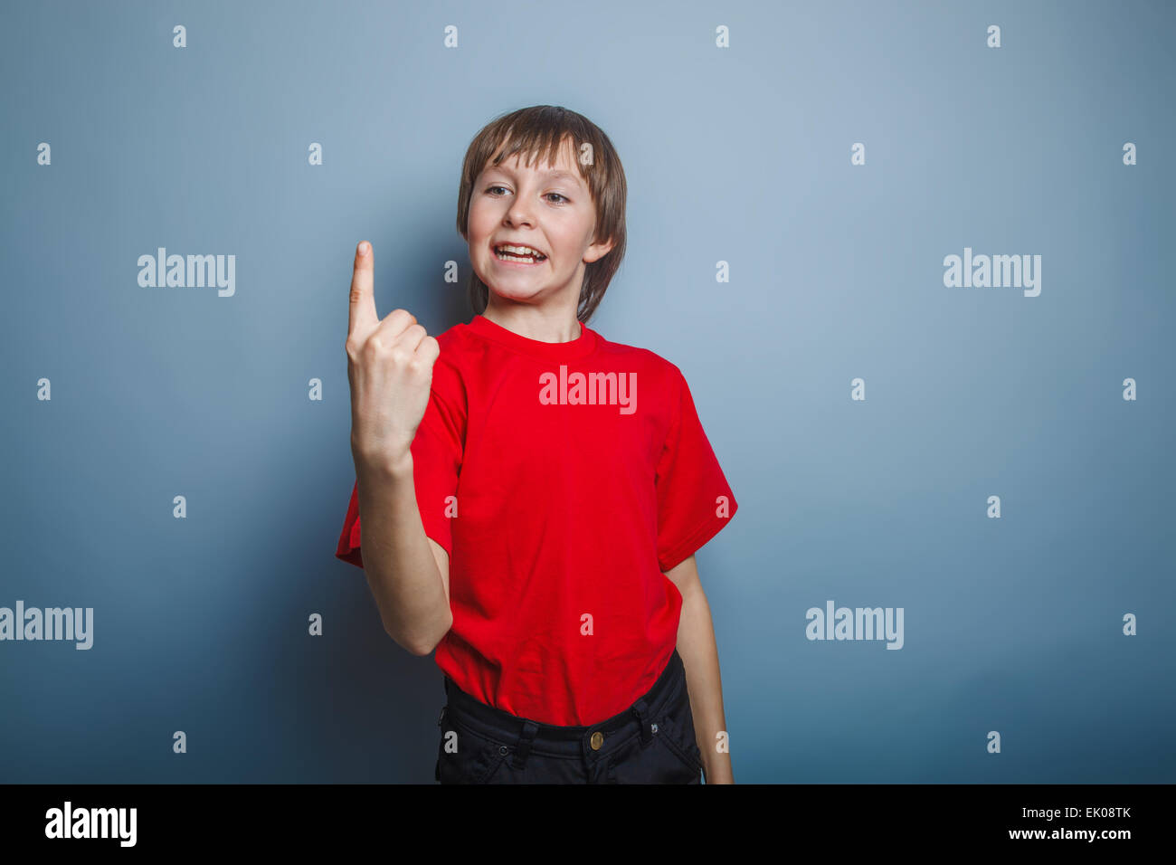 teenager boy brown European appearance in a red shirt is pointin Stock ...