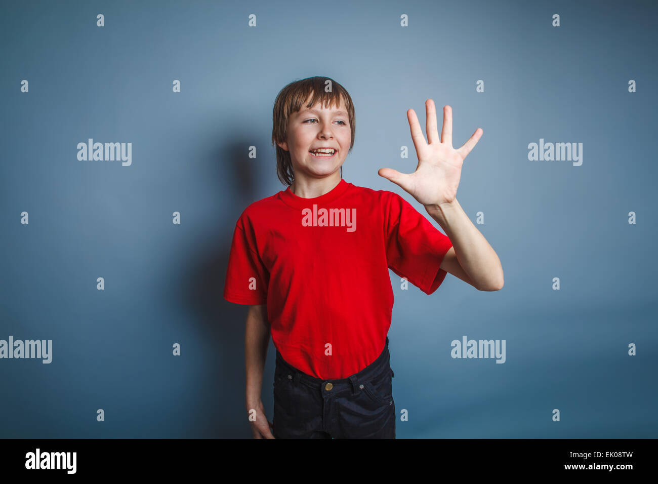 teenager boy brown European appearance in a red shirt is pointin Stock ...