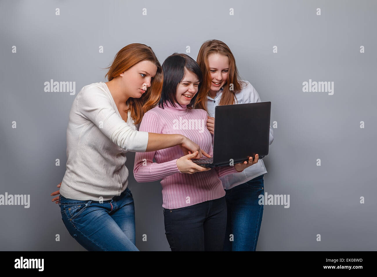 Three girls European appearance girlfriend looking at computer a Stock ...