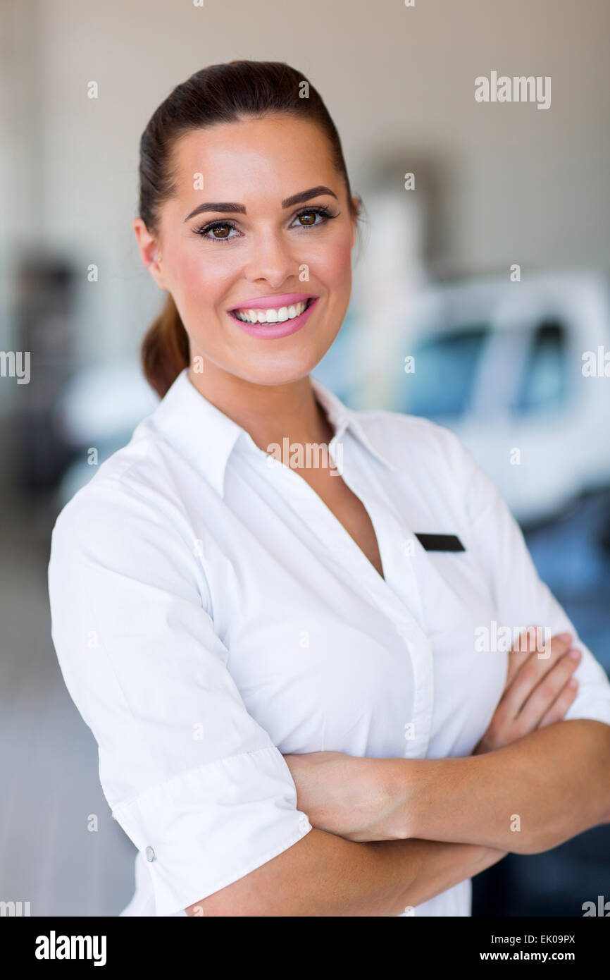 beautiful saleswoman standing at car dealership Stock Photo - Alamy