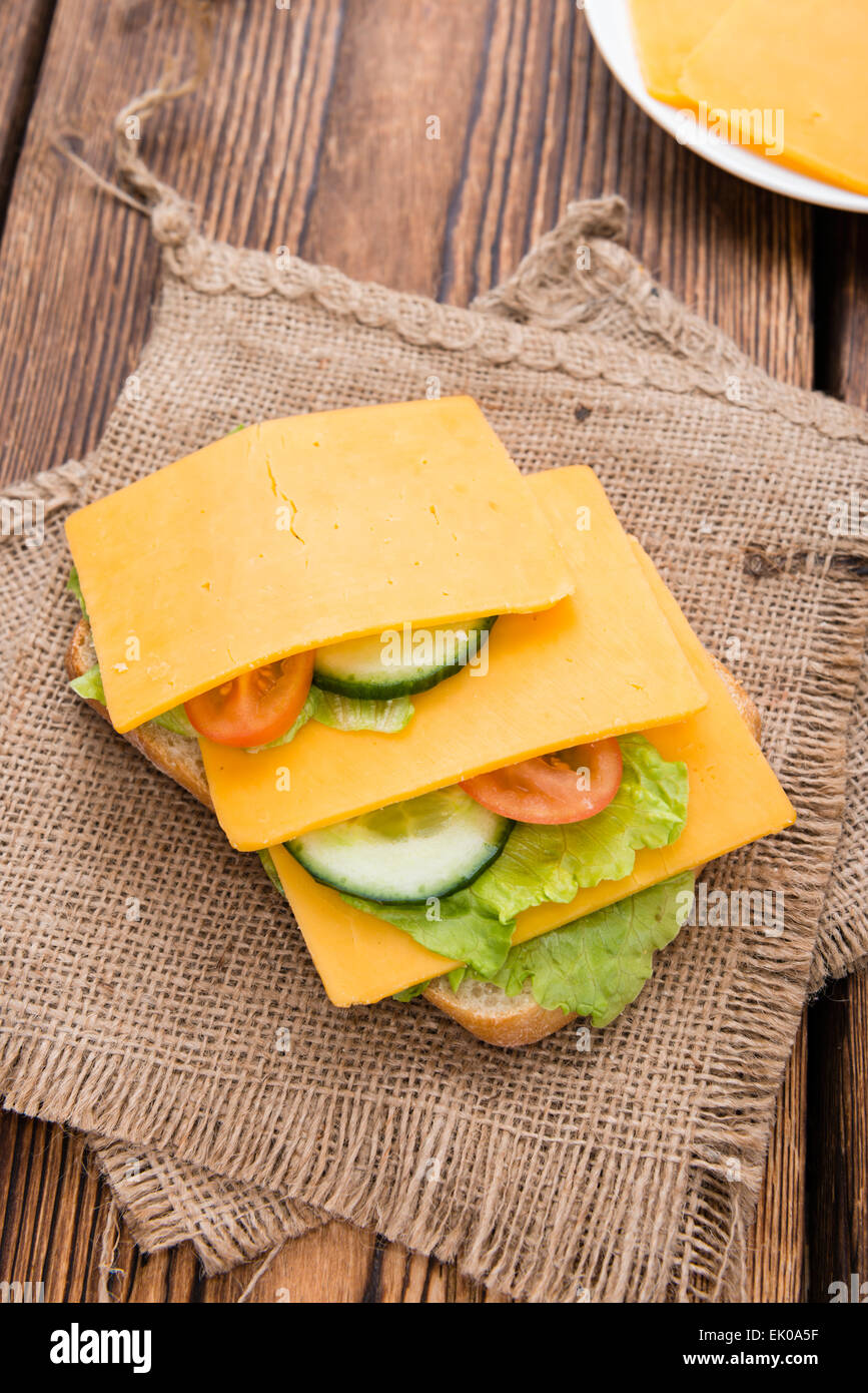 Cheddar Sandwich (close-up shot) with fresh salad on wooden background ...