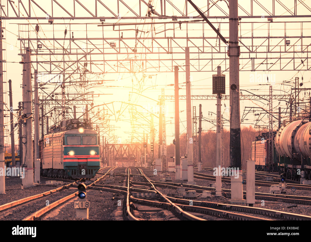 Two long freight trains moves through the station at sunset Stock Photo ...