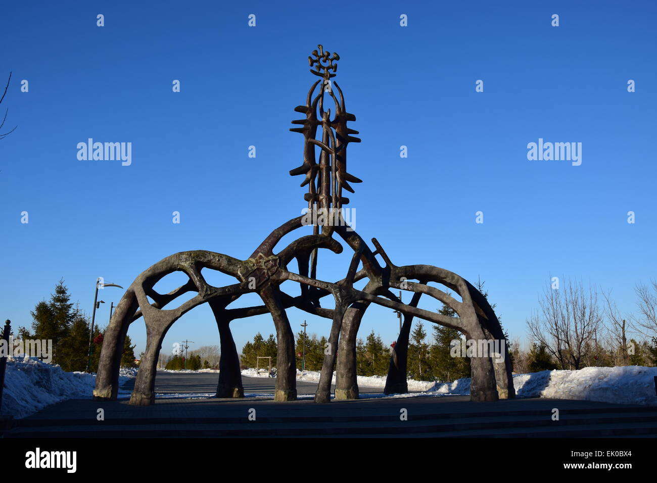 A metal monument in abstract style used as a gate to a park area in ...