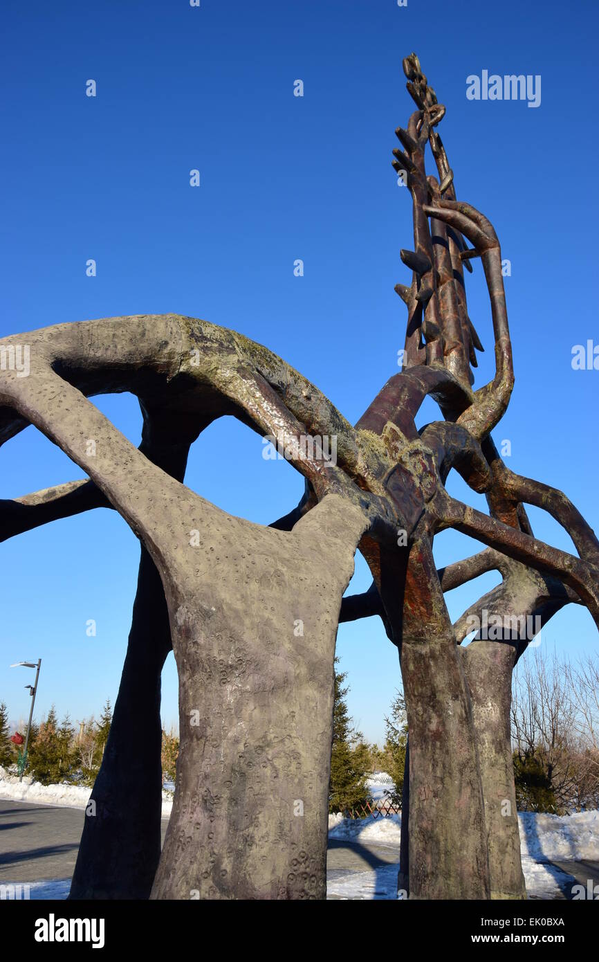 A metal monument in abstract style used as a gate to a park area in ...
