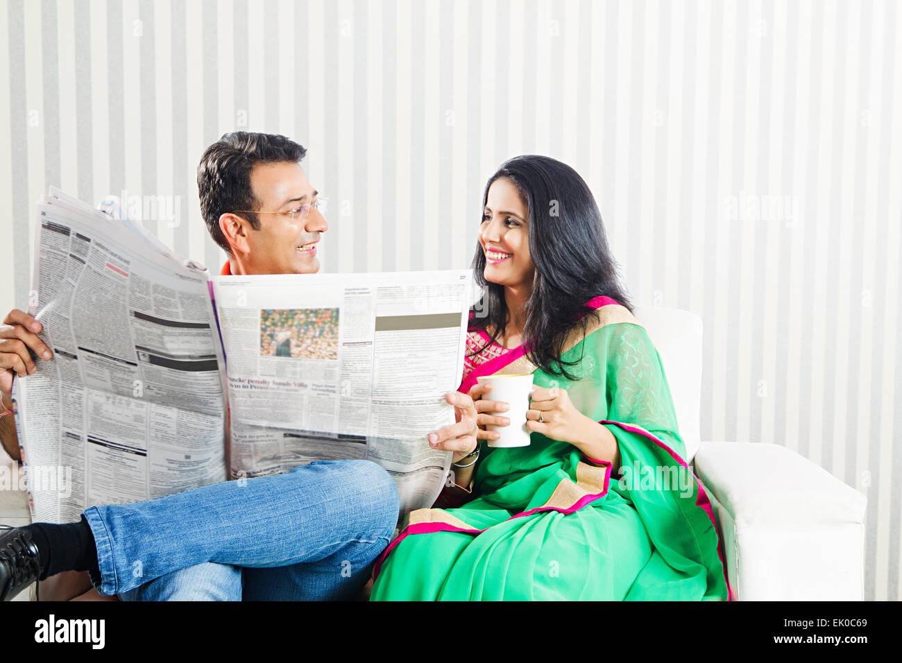 2 indian Married couples home Newspaper reading Stock Photo - Alamy