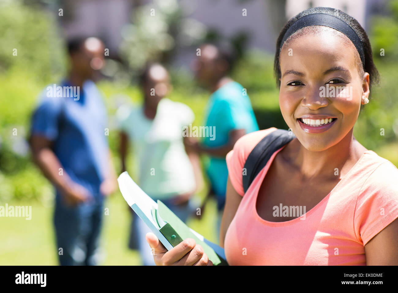 pretty female African college student holding books on campus Stock Photo - Alamy