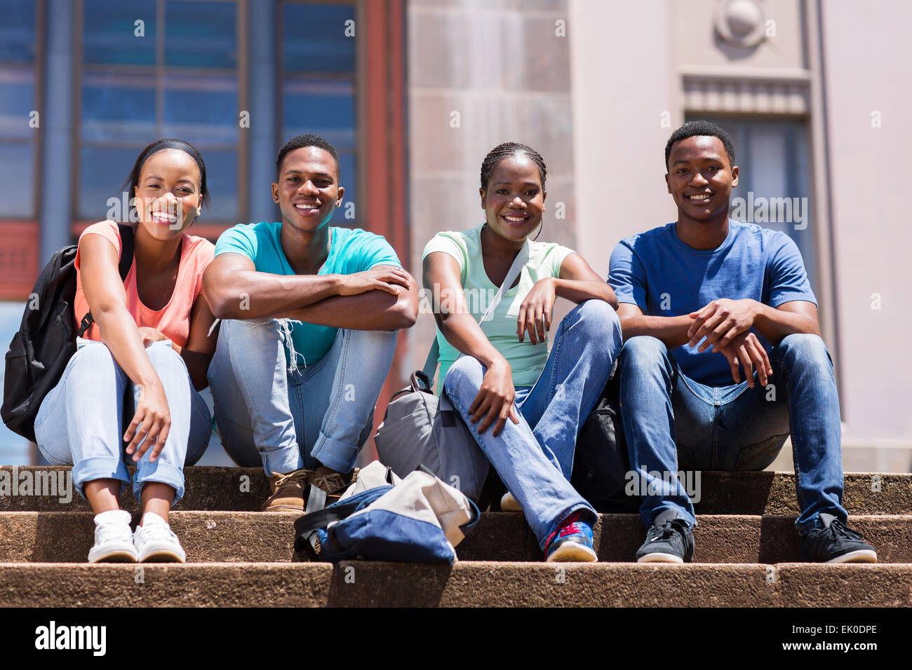 group of happy African student sitting outside college building Stock ...