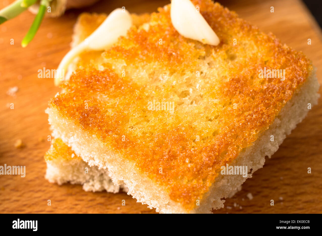 Snack toast grated with garlic on a wooden table Stock Photo - Alamy