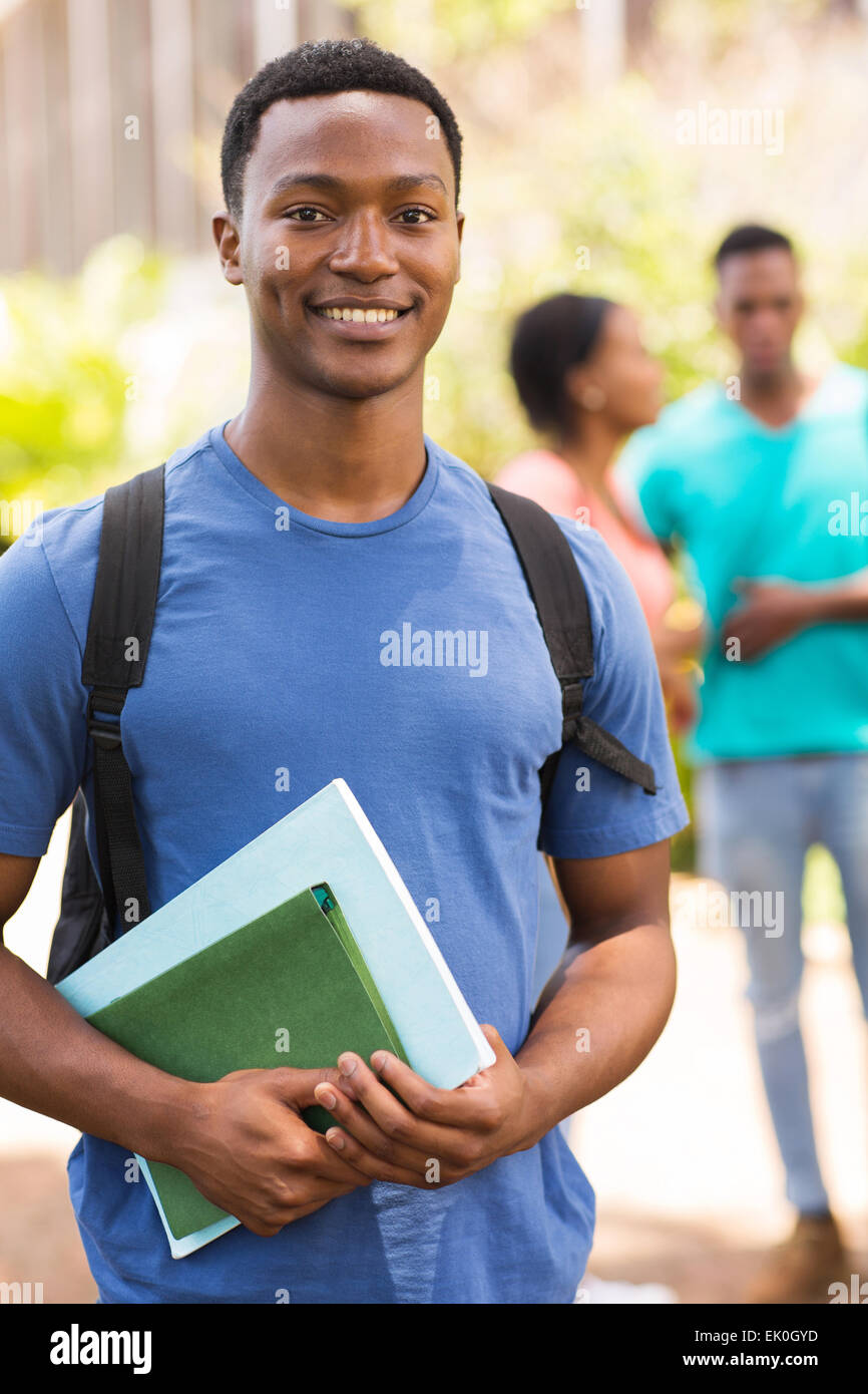 handsome young male student holding books Stock Photo - Alamy