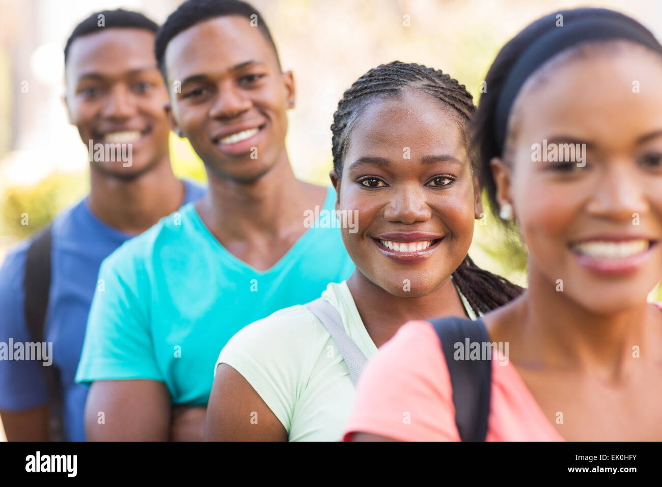group of attractive African American college students outside on campus ...