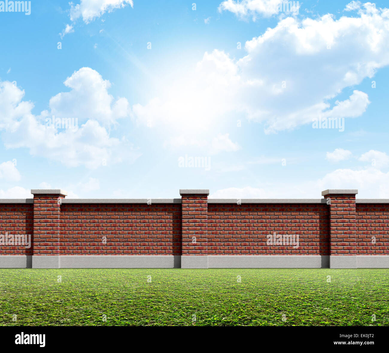 An front view of a regular domestic brick wall on a green grass and ...