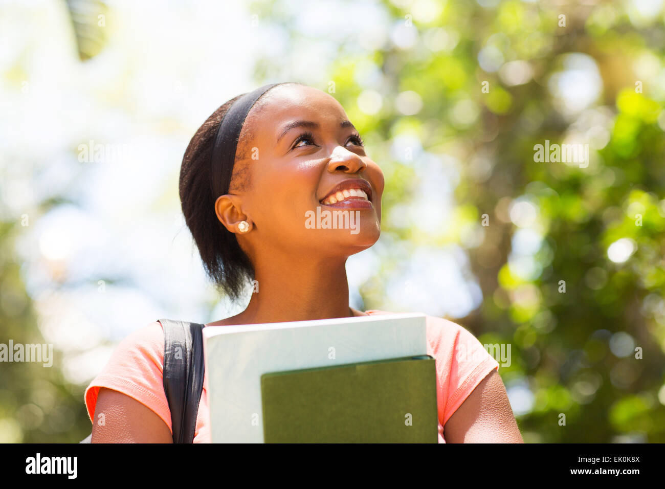 happy young female college student looking up Stock Photo - Alamy