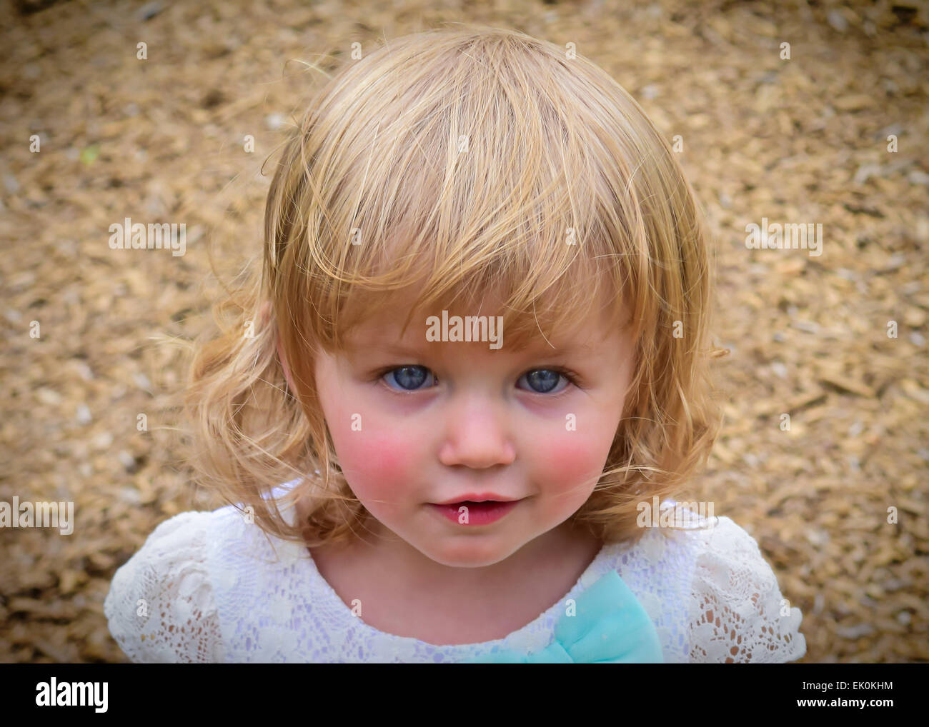 Portrait of a small, blond, girl at a playground Stock Photo - Alamy