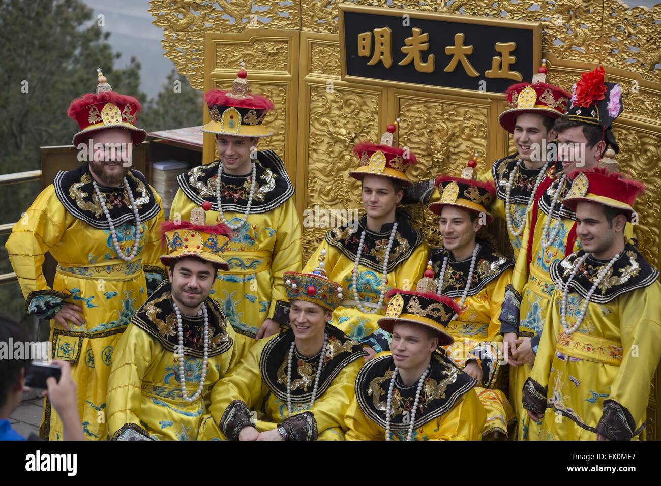 A group of foreigners wear the dragon robes from Qing Dynasty of China ...
