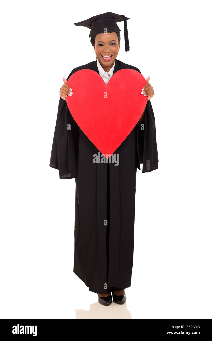 beautiful African college graduate holding heart shape on white ...
