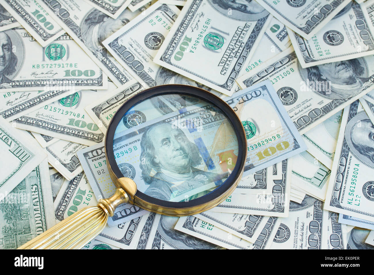 Pile dollars under magnifying glass hi-res stock photography and images ...