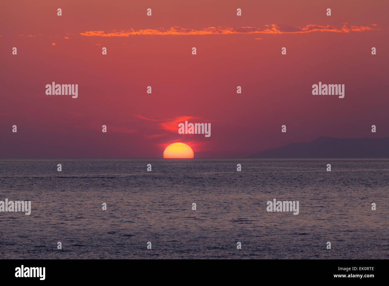 Amazing cloudy red dawn over sea Stock Photo - Alamy
