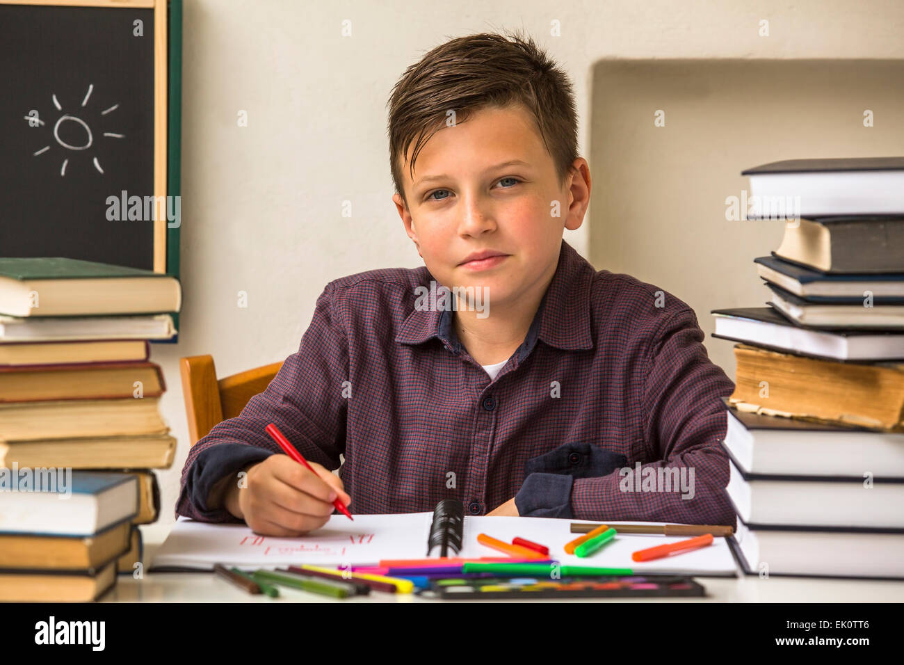 Pupil elementary school does homework Stock Photo - Alamy