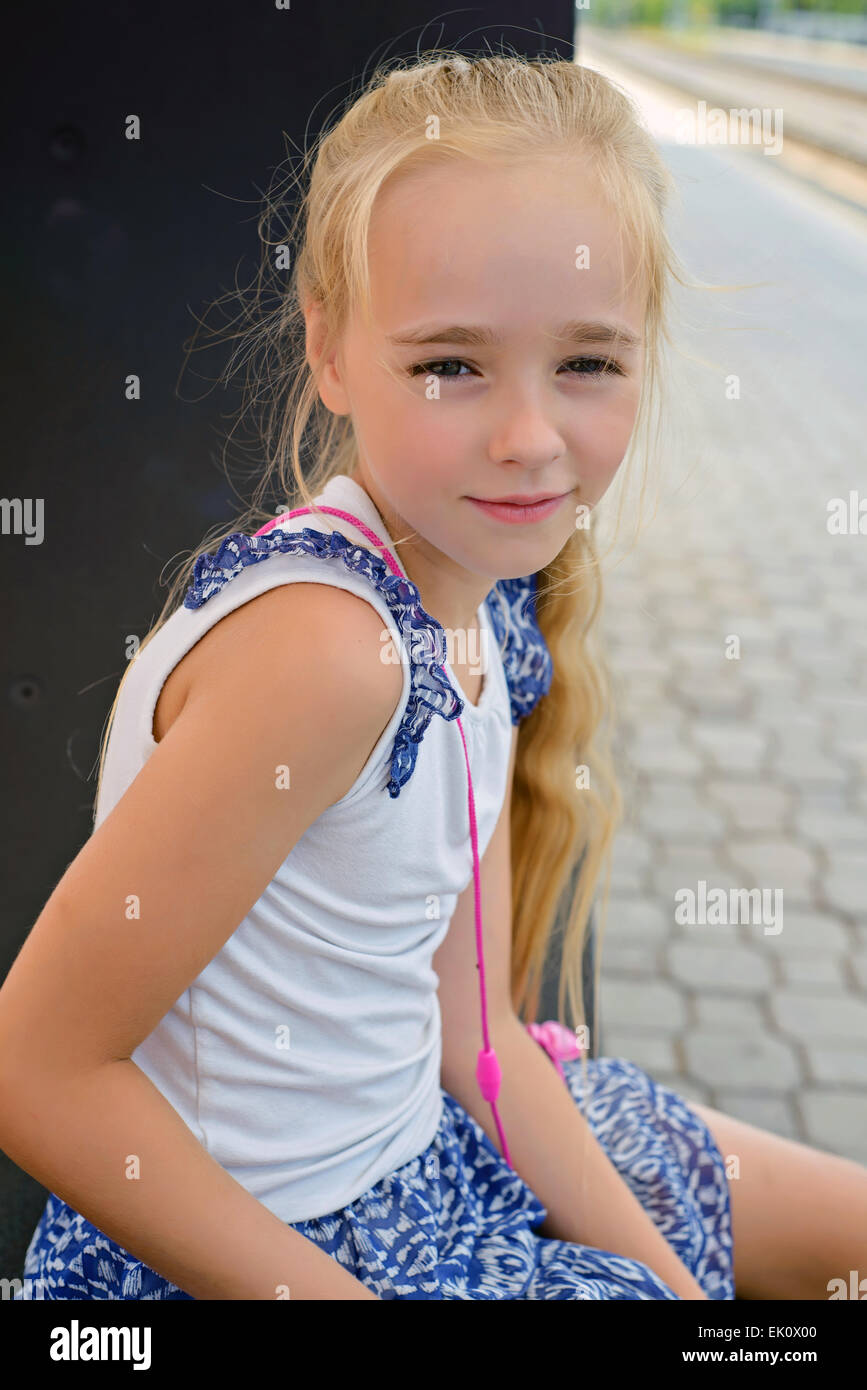 Little Girl Sitting On The Bench Stock Photo Alamy