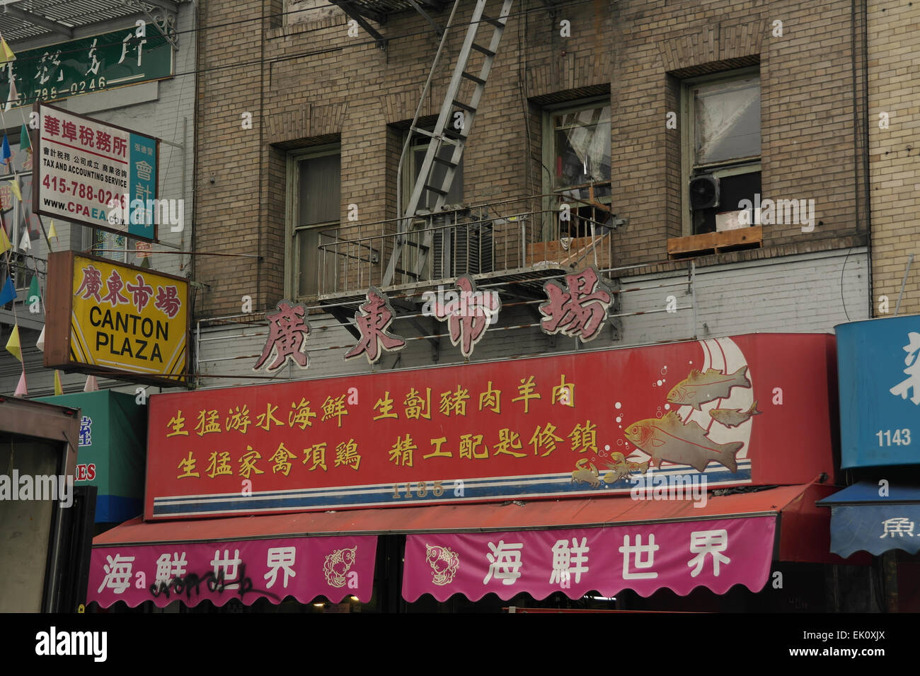 Red marquee Cantonese characters, below brick building windows, Canton ...