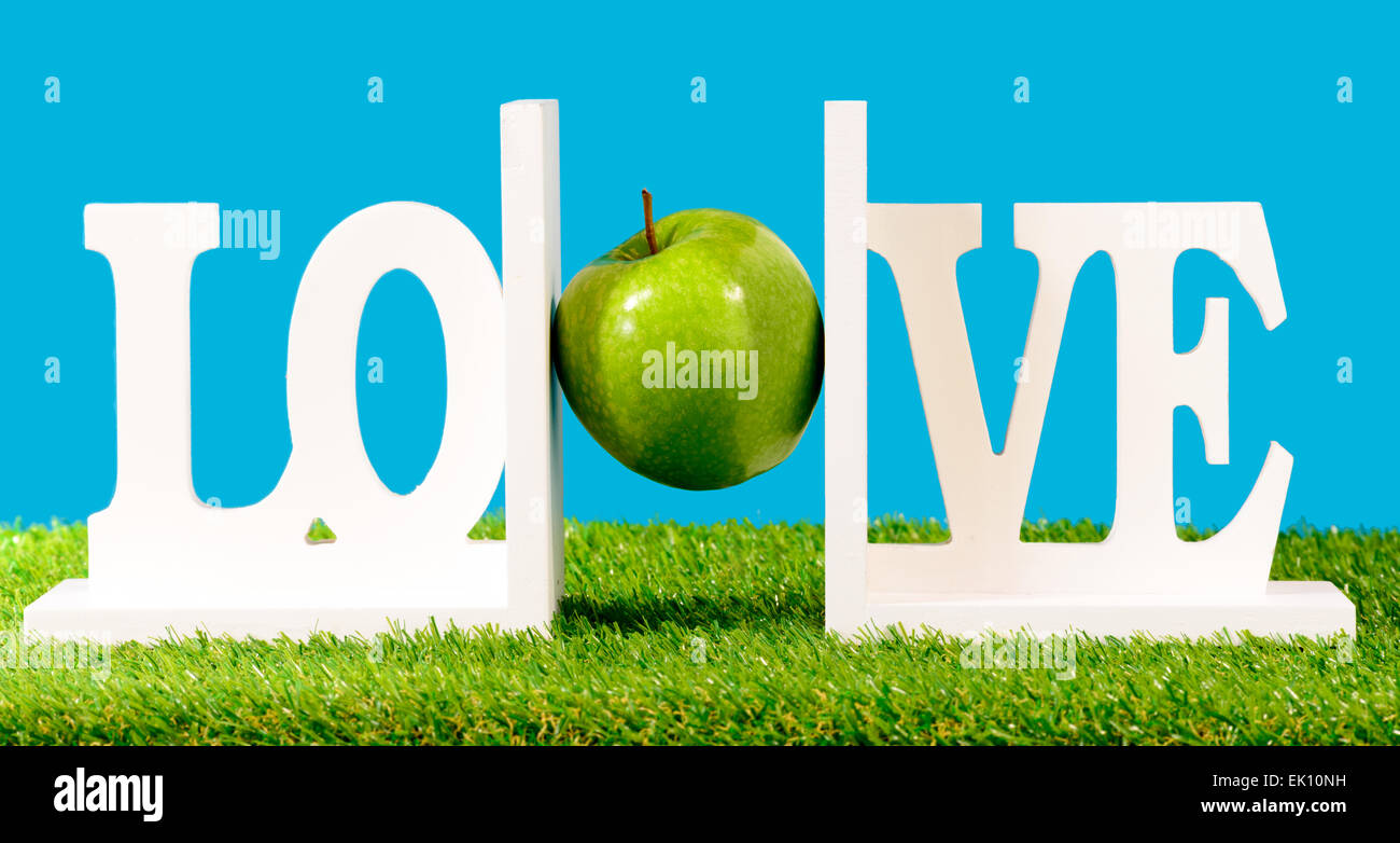 we love apples in the green grass Stock Photo - Alamy