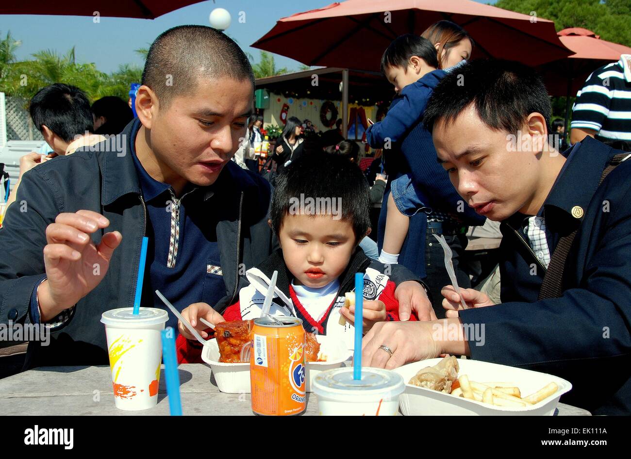 Hong Kong, China: Little Chinese boy with his father and uncle having ...