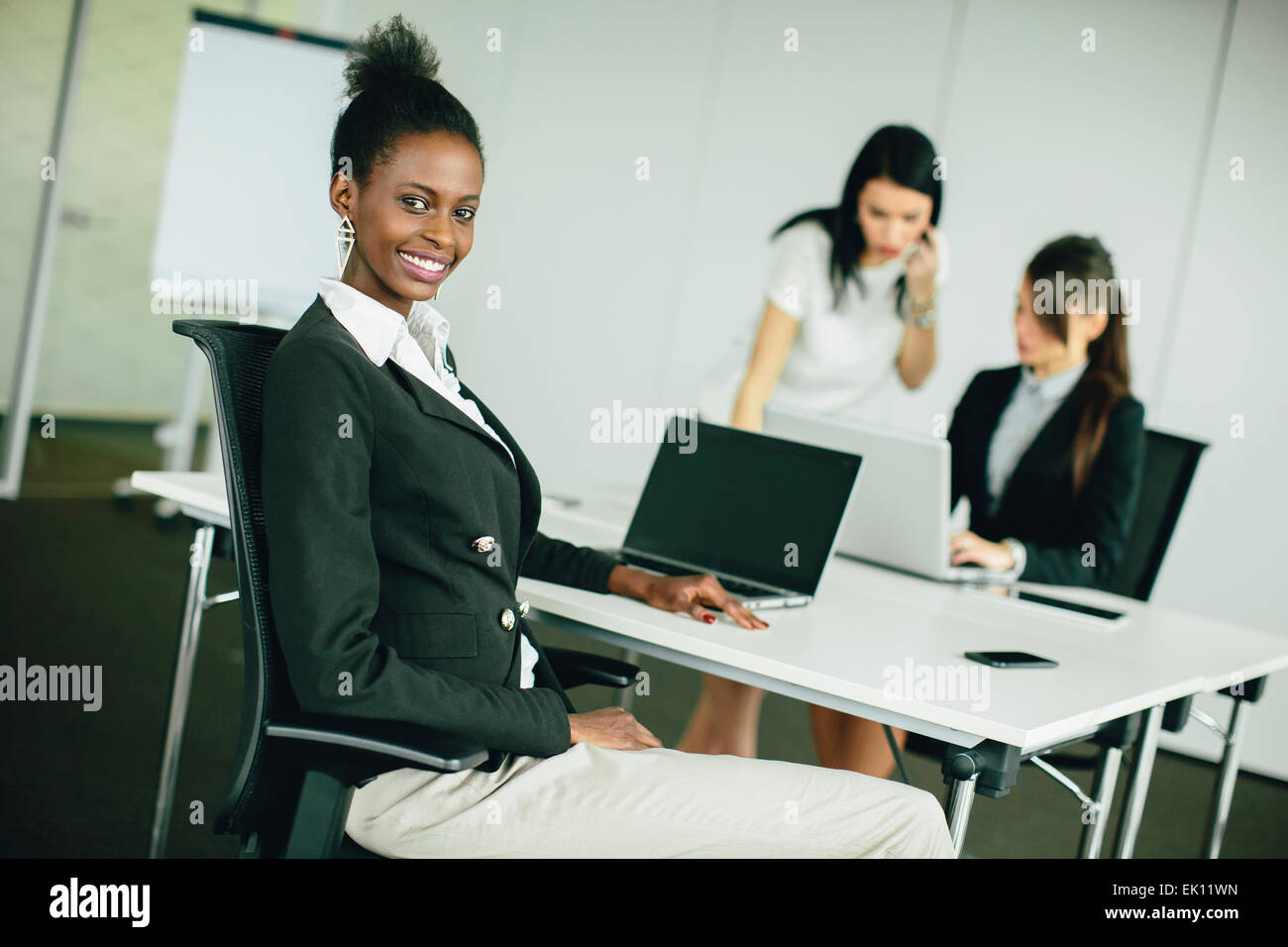 Young women working in the office Stock Photo - Alamy