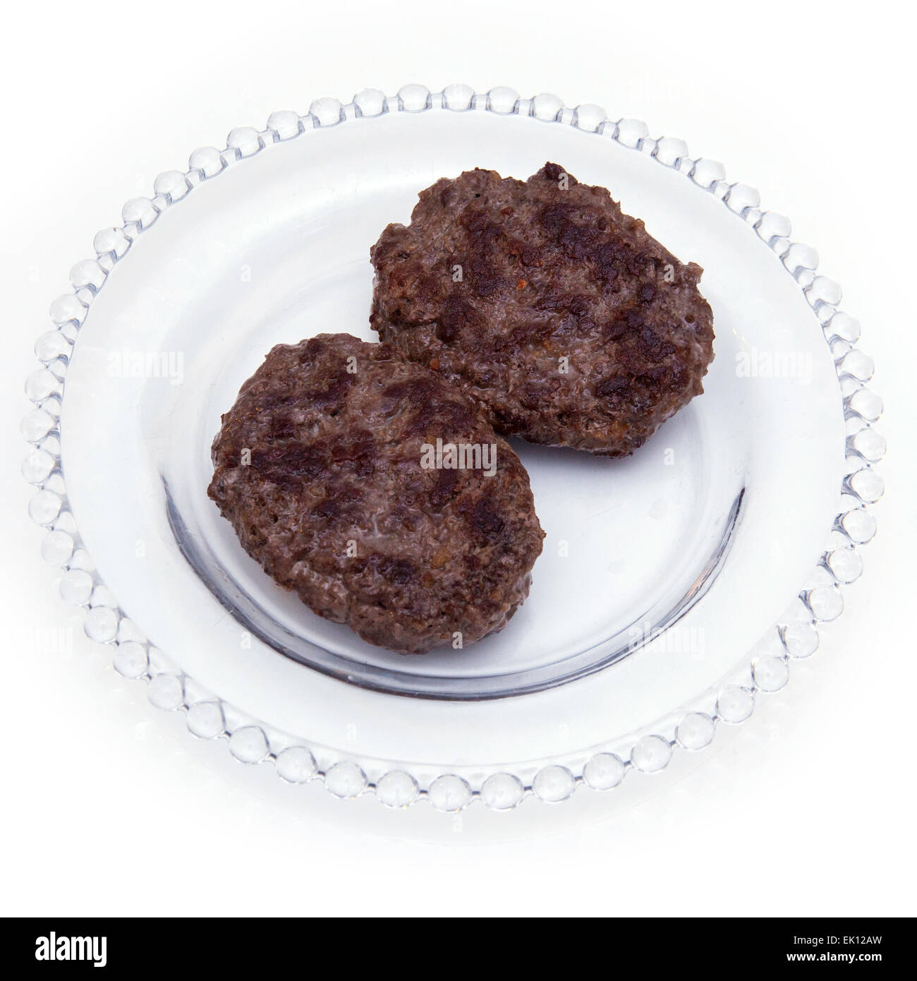 Cooked kangaroo meat burger on a glass plate, isolated on a white ...