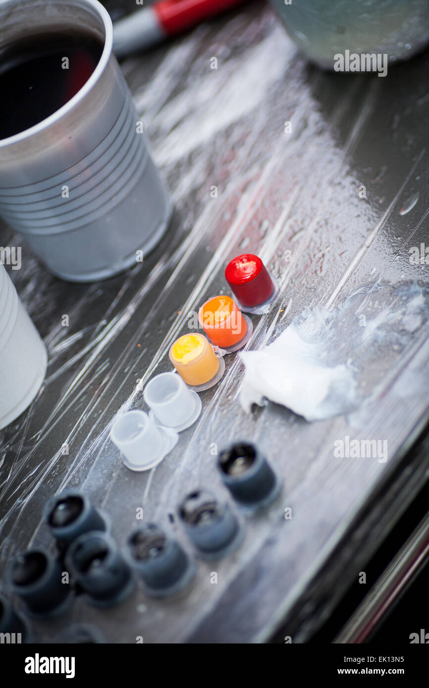 Colourful tattoo ink in small cups ready for being used on a tattoo ...