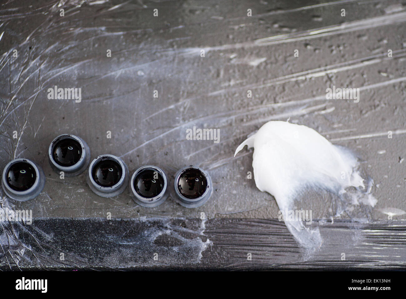 Black tattoo ink in small cups ready for being used on a tattoo, shot ...