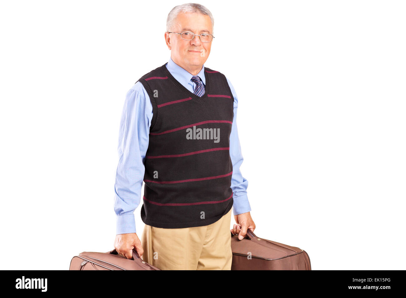 Smiling senior gentleman carrying two bags and looking at camera ...