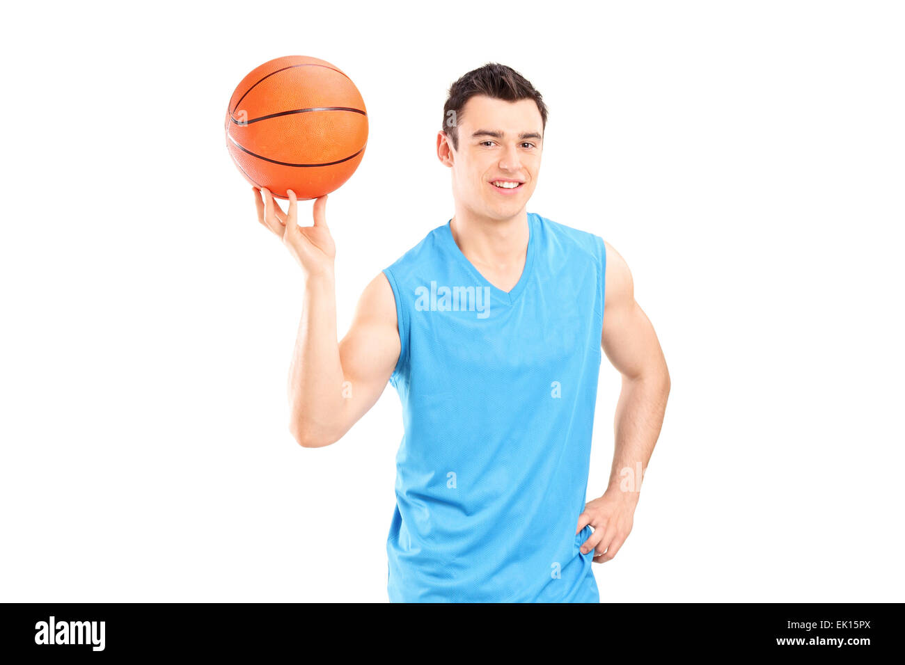 Young smiling basketball player in blue dress posing with a ball ...