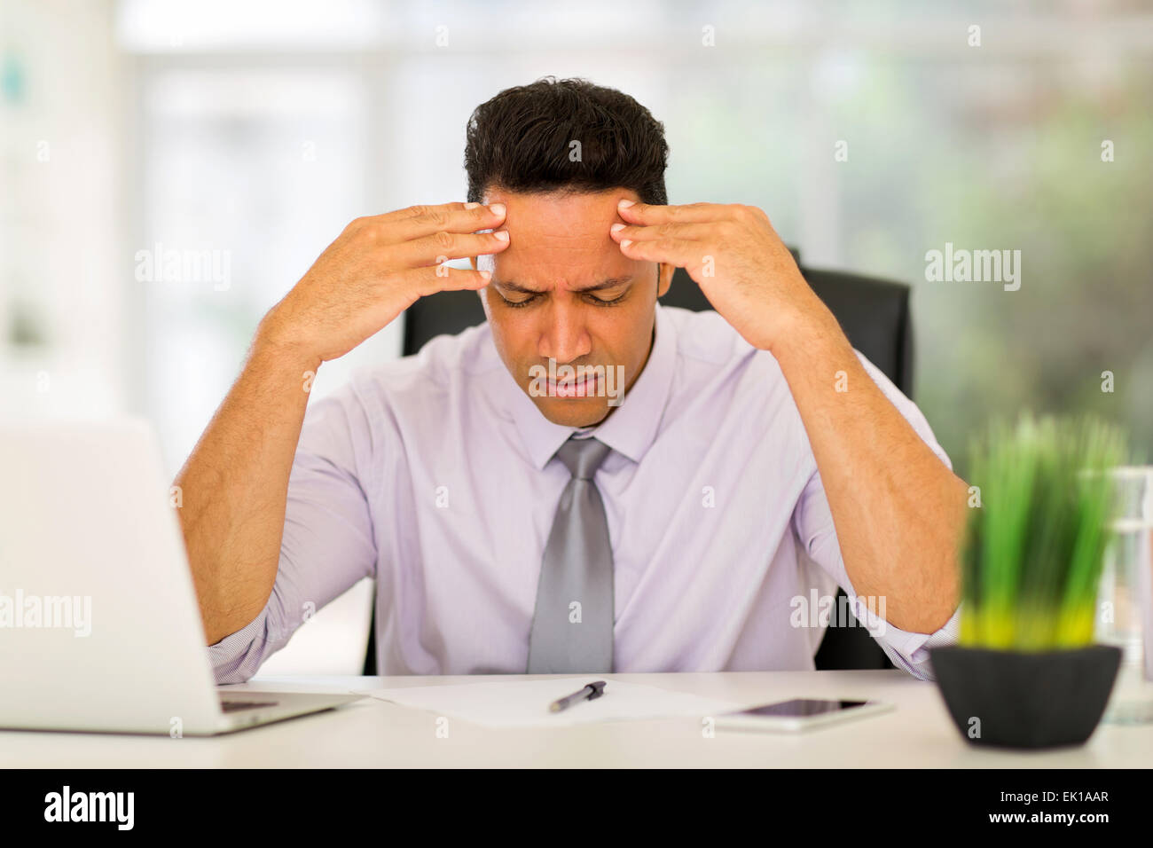 overworked businessman sitting in office Stock Photo - Alamy