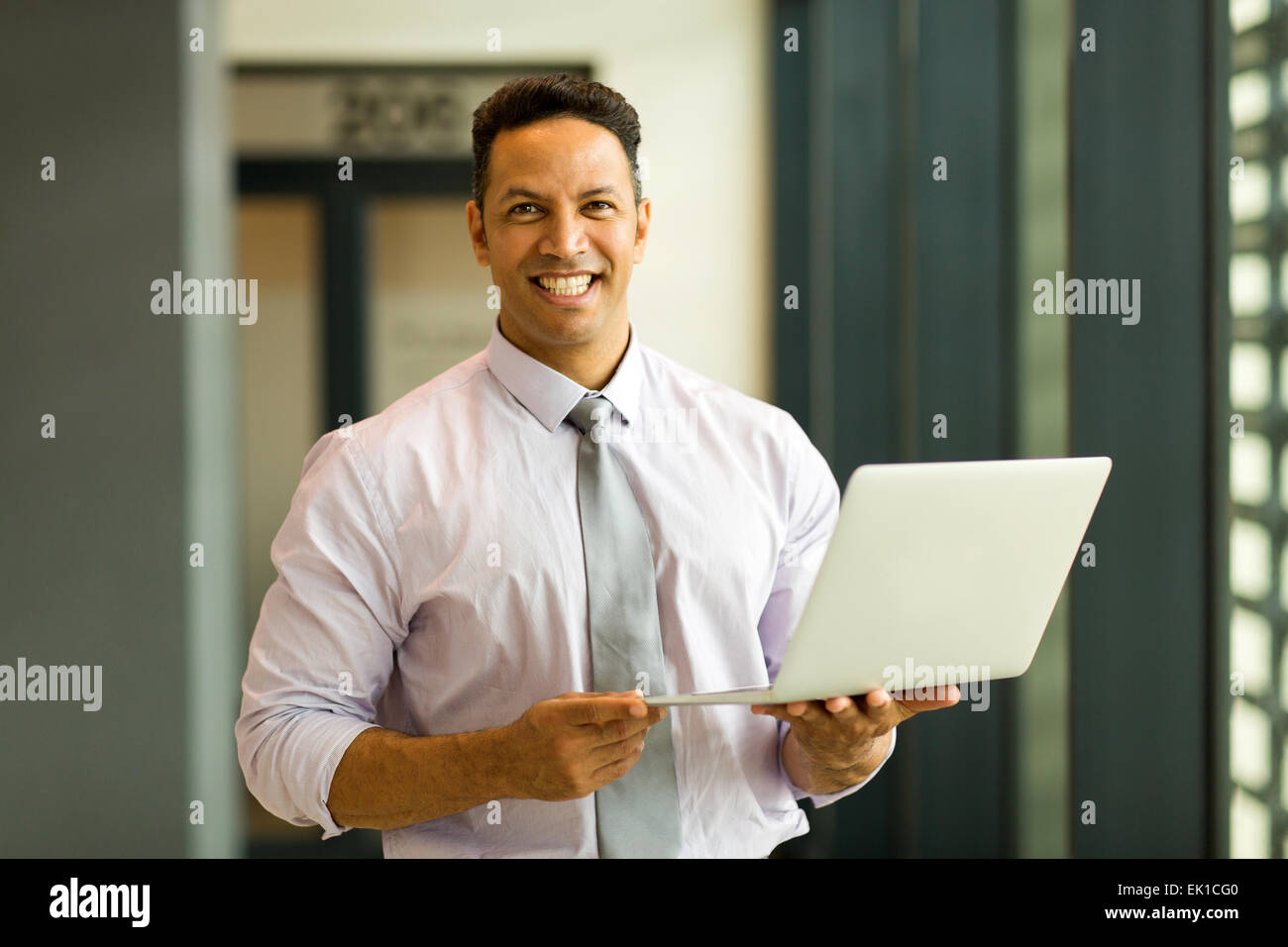 Office employee holding laptop hi-res stock photography and images - Alamy