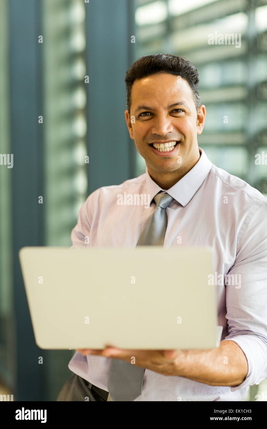 good looking corporate worker holding laptop Stock Photo - Alamy
