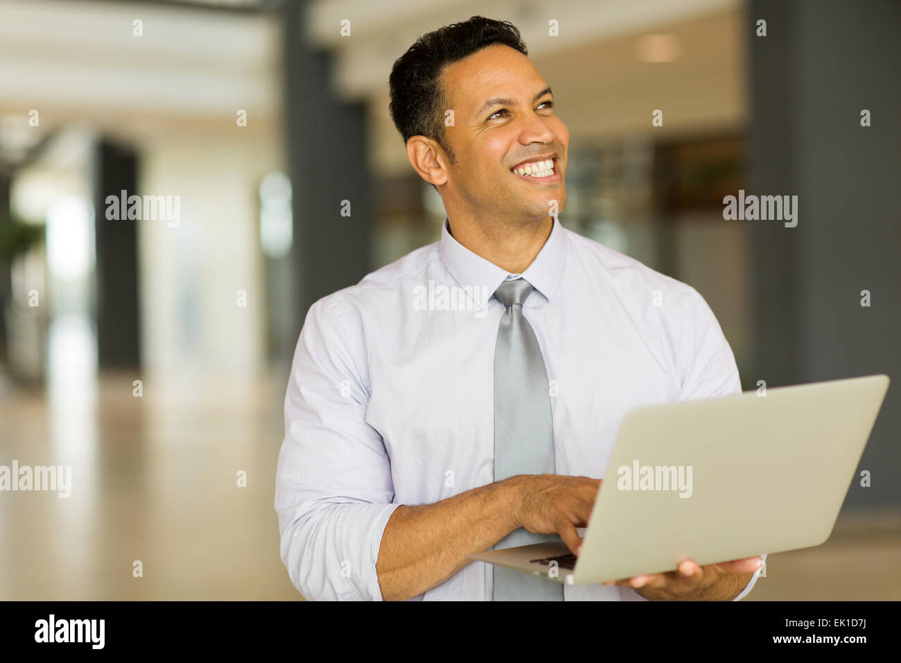 Business man holding laptop computer hi-res stock photography and ...